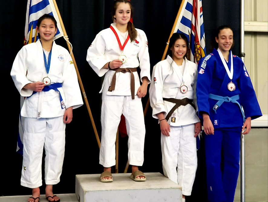 Isla Diesmos of Calgary (extreme left) wins a silver medal - Alberta ...